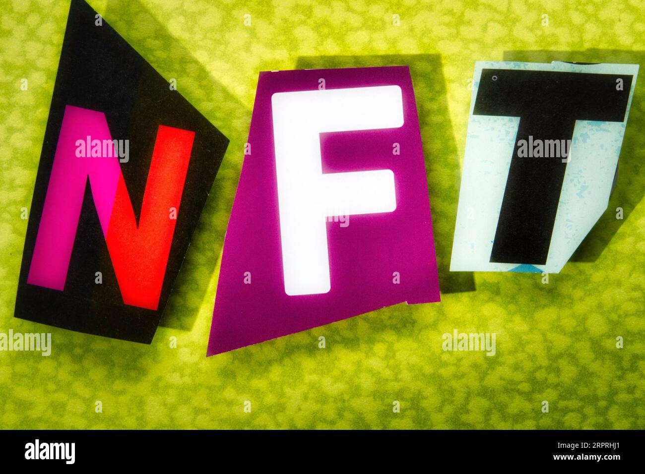 The acronym "NFT" (Non-Fungible Token) using cut-out paper letters in ...