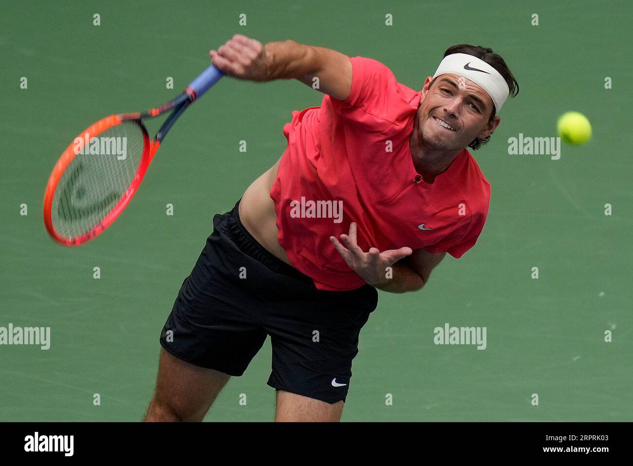 Taylor Fritz, of the United States, serves to Novak Djokovic, of Serbia ...