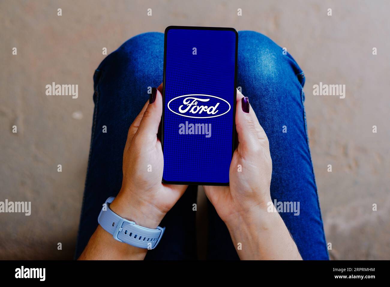 In this photo illustration, the Ford logo is displayed on a smartphone ...