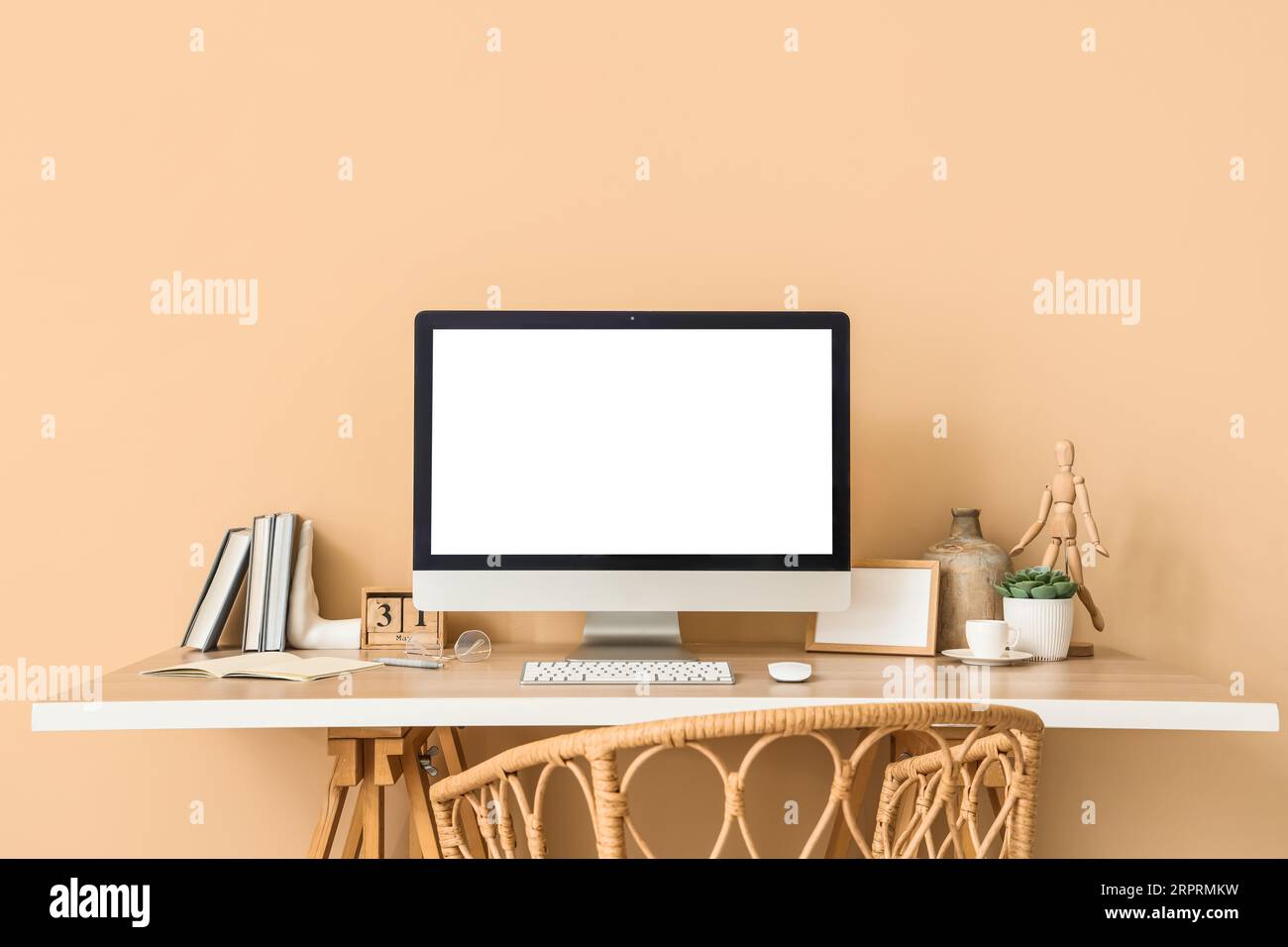 Modern workplace with blank computer monitor near beige wall Stock ...