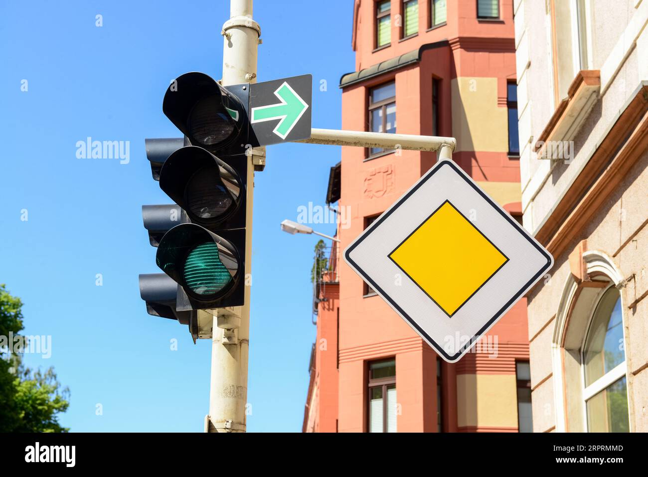 View of green traffic light with road signs in city, closeup Stock ...