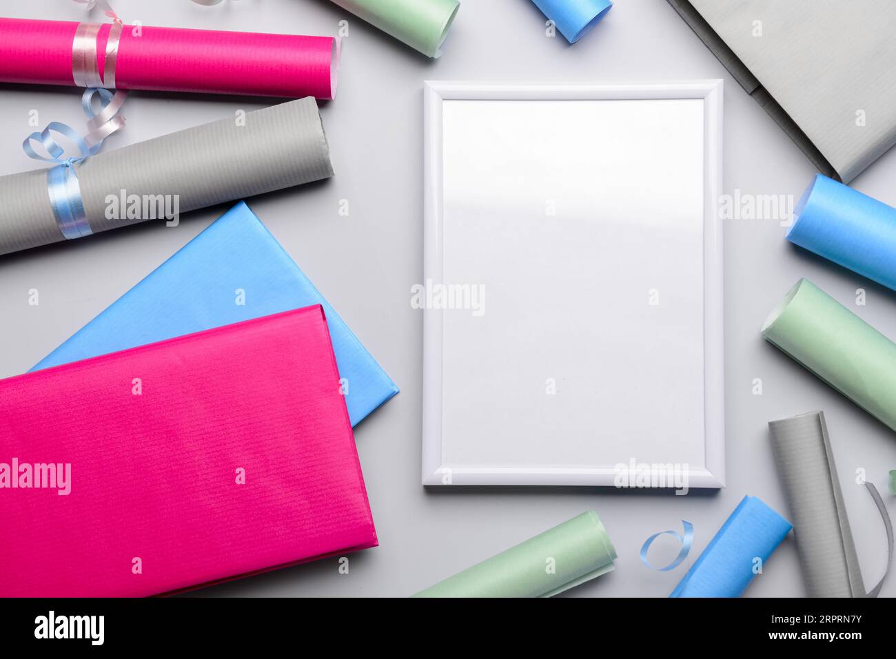 Blank frame with books and wrapping paper on light background Stock ...