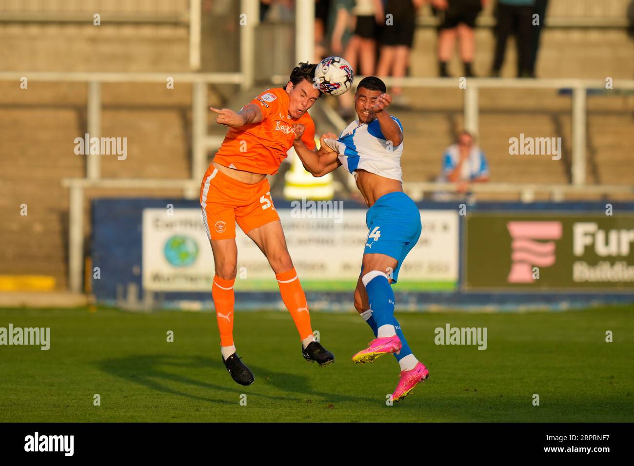 Courtney Duffus #14 of Barrow competes for a header with Doug Tharme ...