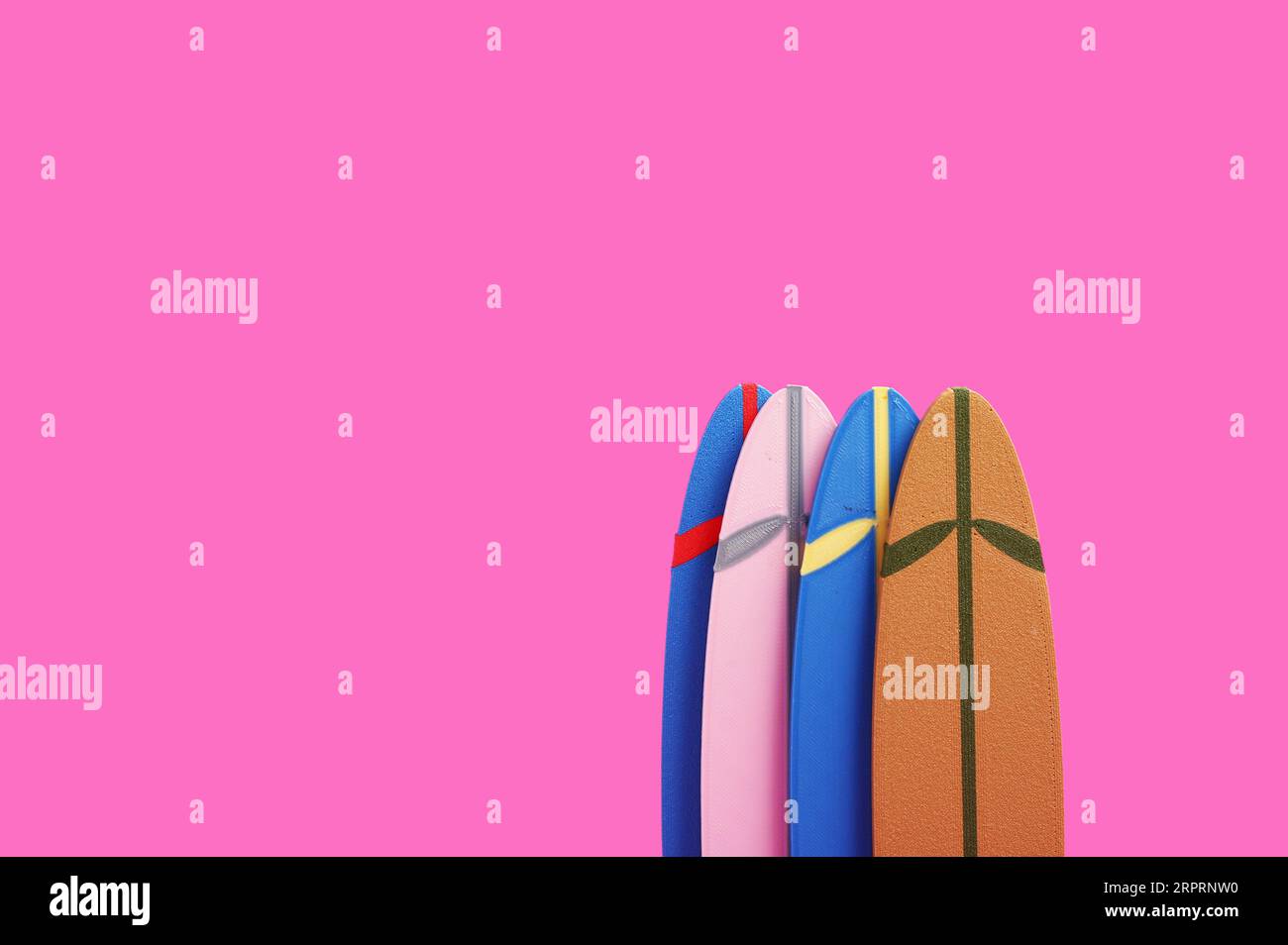 Different mini surfboards on pink background Stock Photo - Alamy