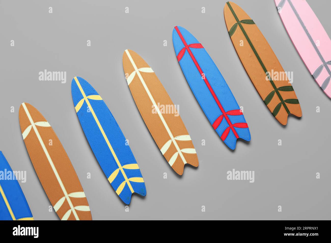 Different mini surfboards on grey background Stock Photo - Alamy