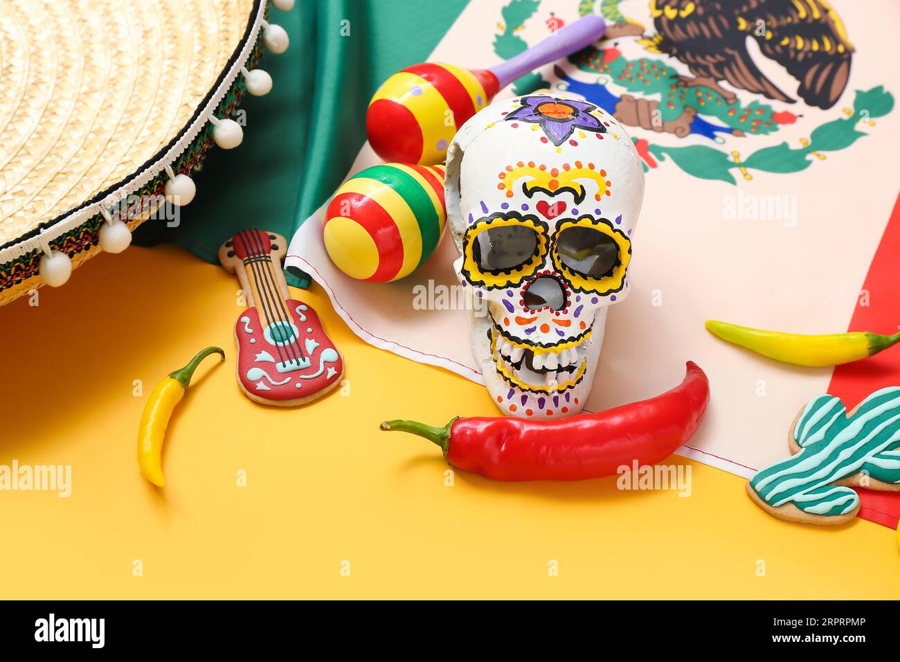 Painted sugar skull, maracas, Mexican flag and chilli peppers on yellow ...