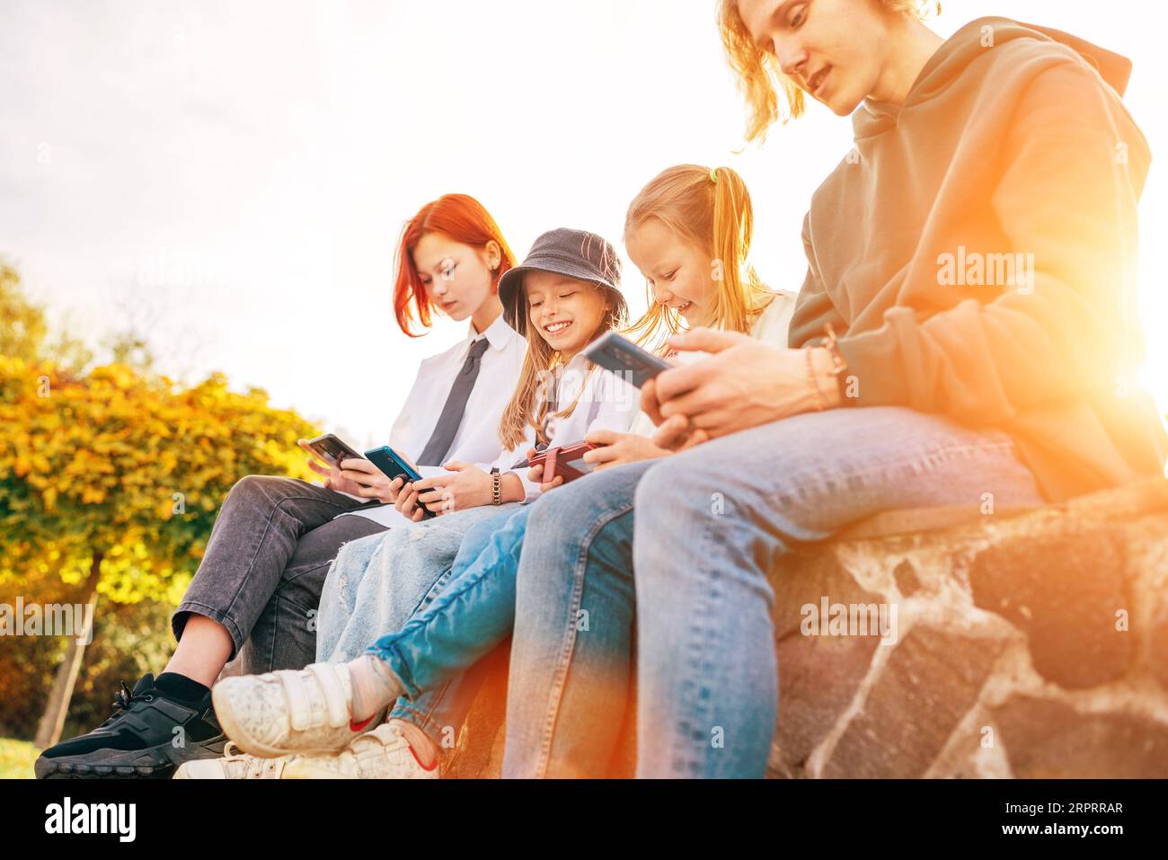 Teenager boy and a sister girls kids sitting and browsing their ...