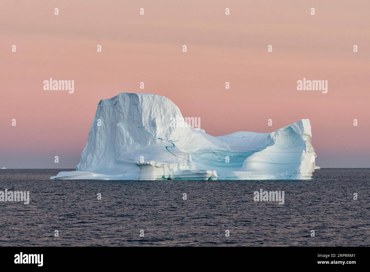 Huge floating iceberg in Disko Bay in the arctic early morning twilight ...