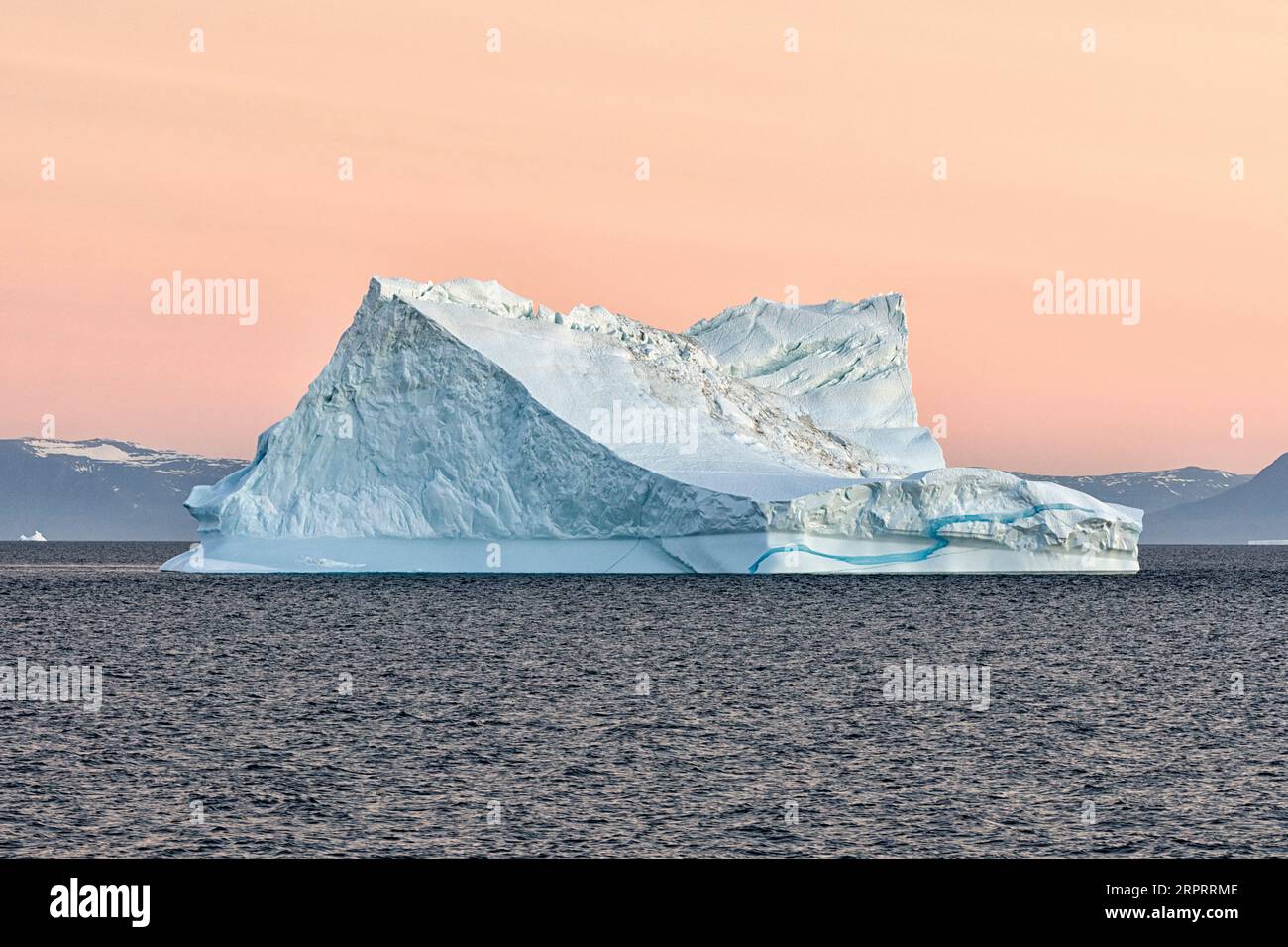 Huge floating pinacle iceberg in Disko Bay in the arctic early morning ...