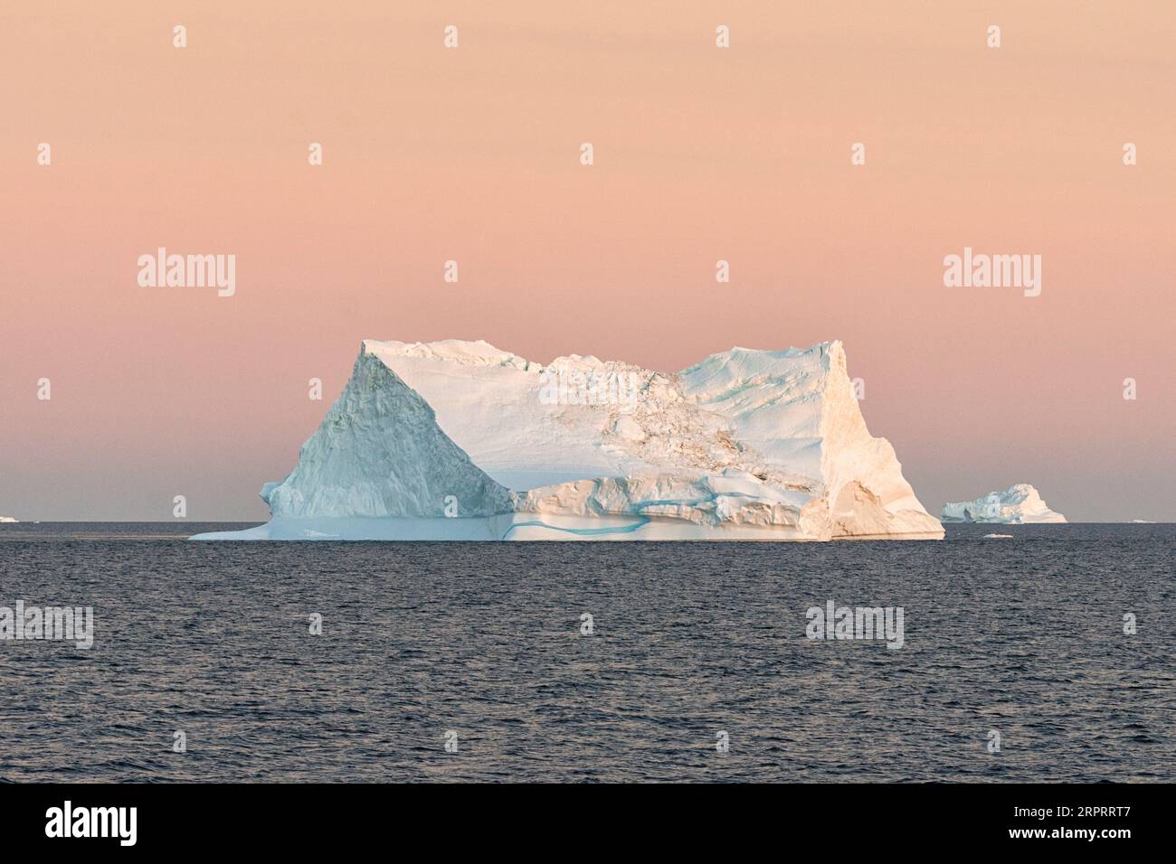 Huge floating iceberg in Disko Bay in the arctic early morning twilight ...