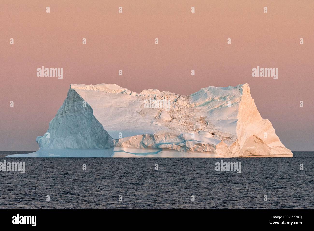 Huge floating iceberg in Disko Bay in the arctic early morning twilight ...