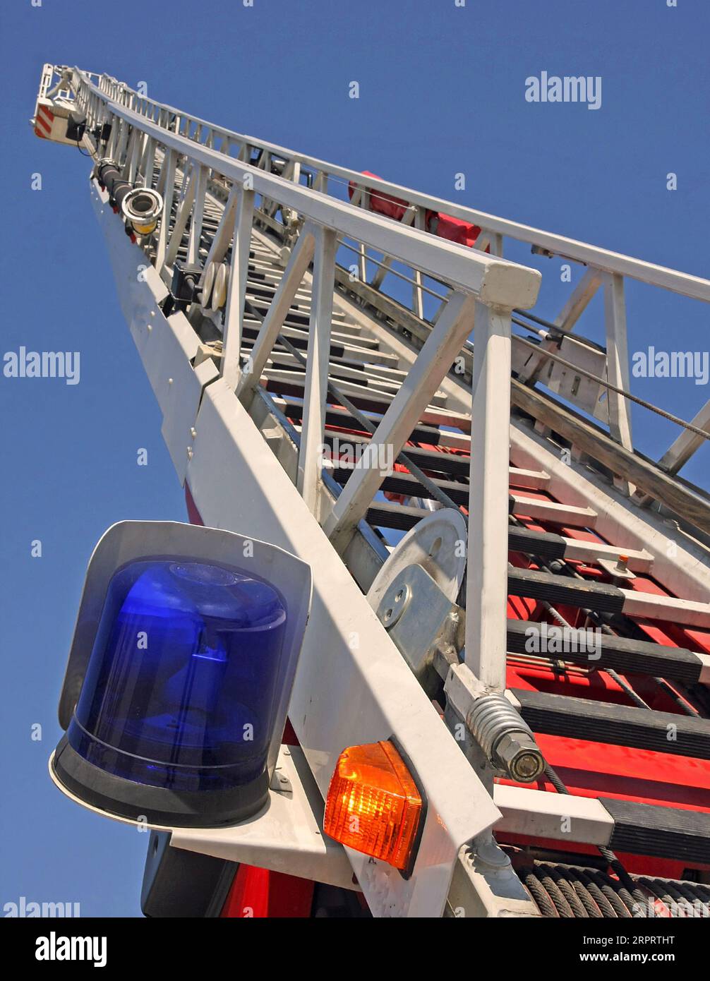 Long metal ladder of the fire truck ladder and blue flashing light ...