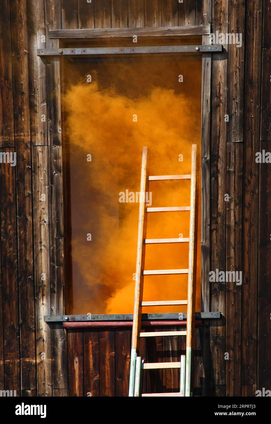 empty window with a ladder and thick orange toxic smoke comes out Stock ...