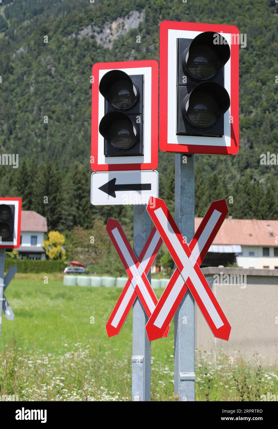 many road signs of attention to the train level crossing on the rails ...
