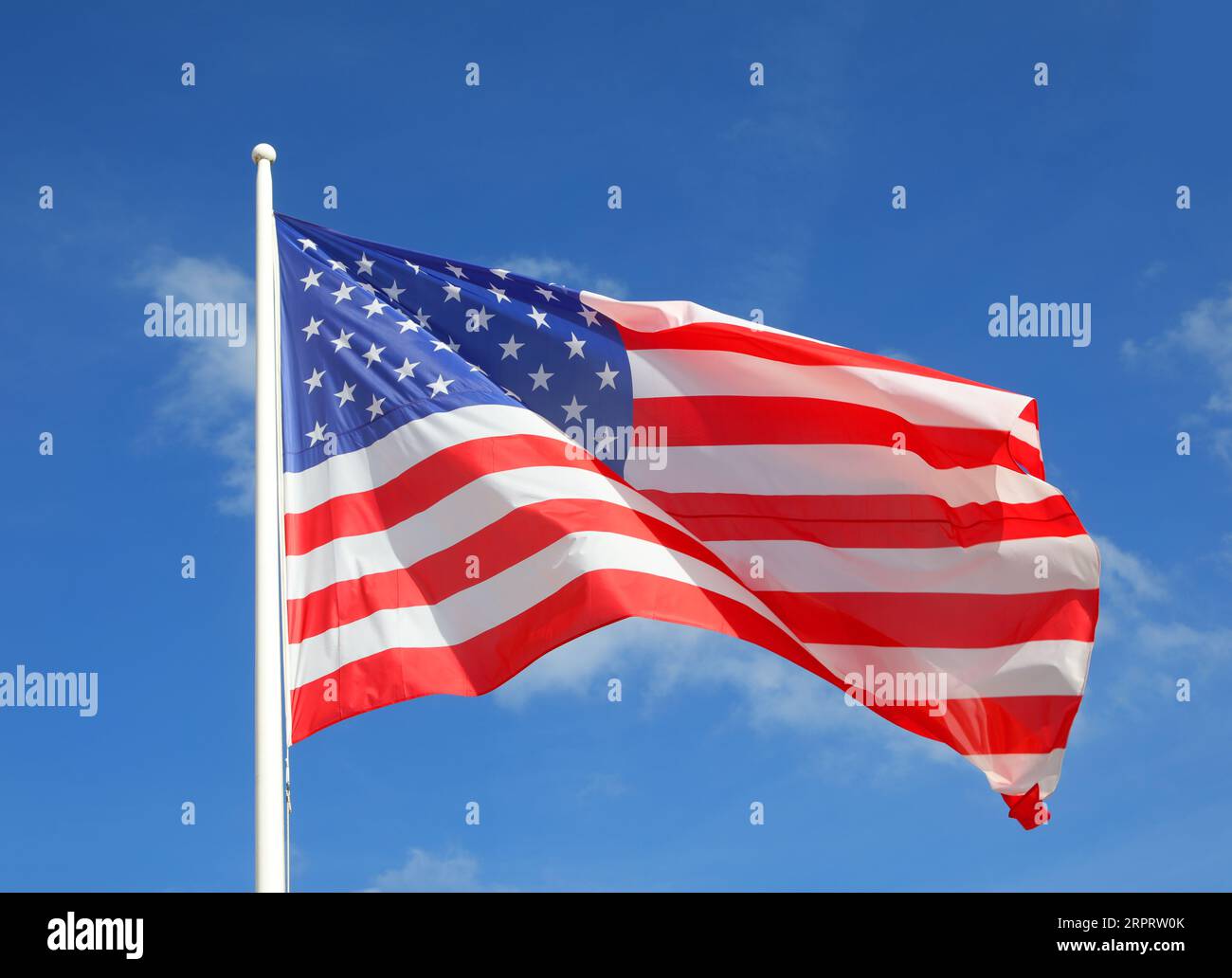 bright American flag with red and white stripes and stars waving in the ...