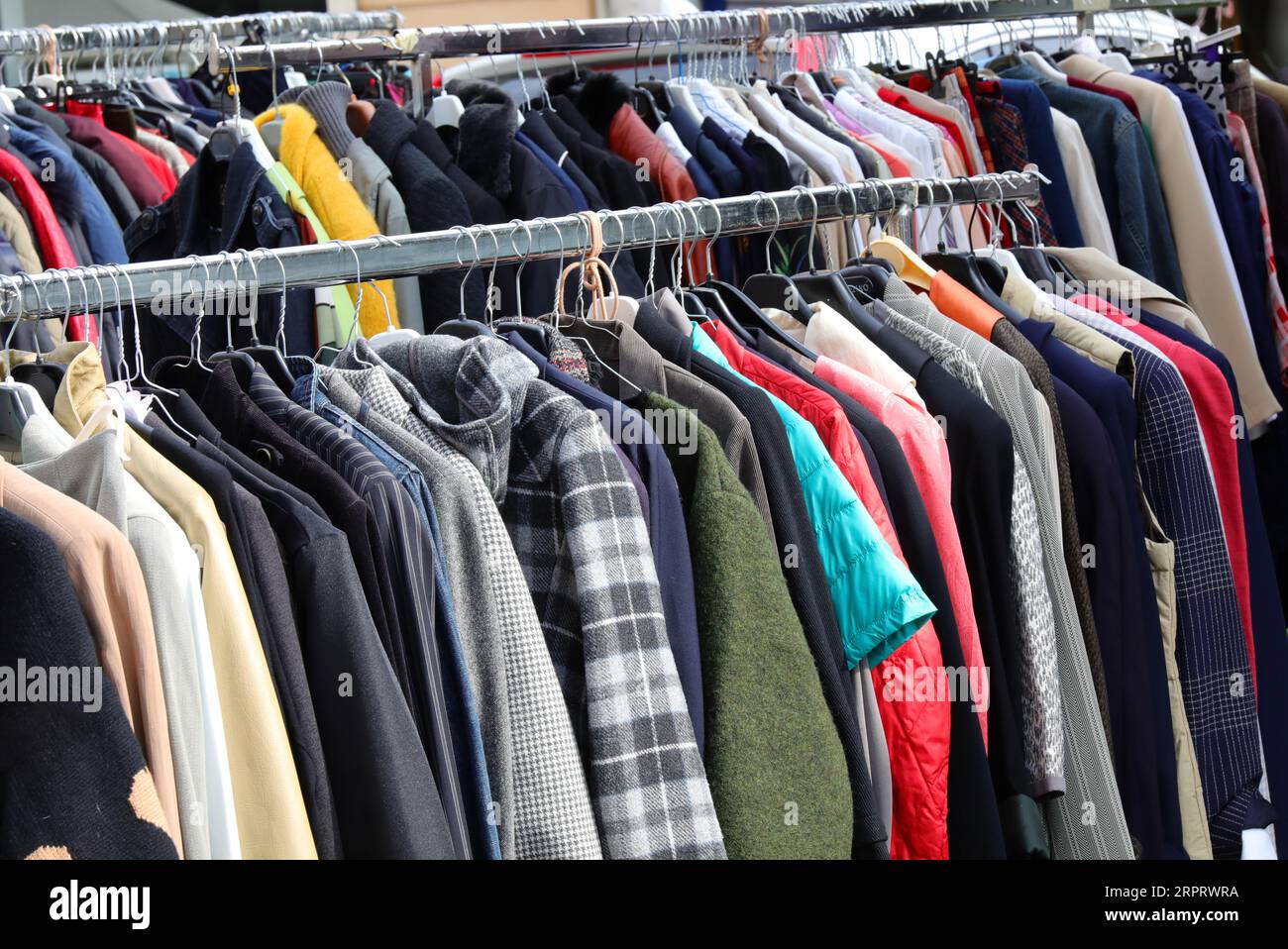 vintage used clothes and new dresses in the stall at the flea market ...
