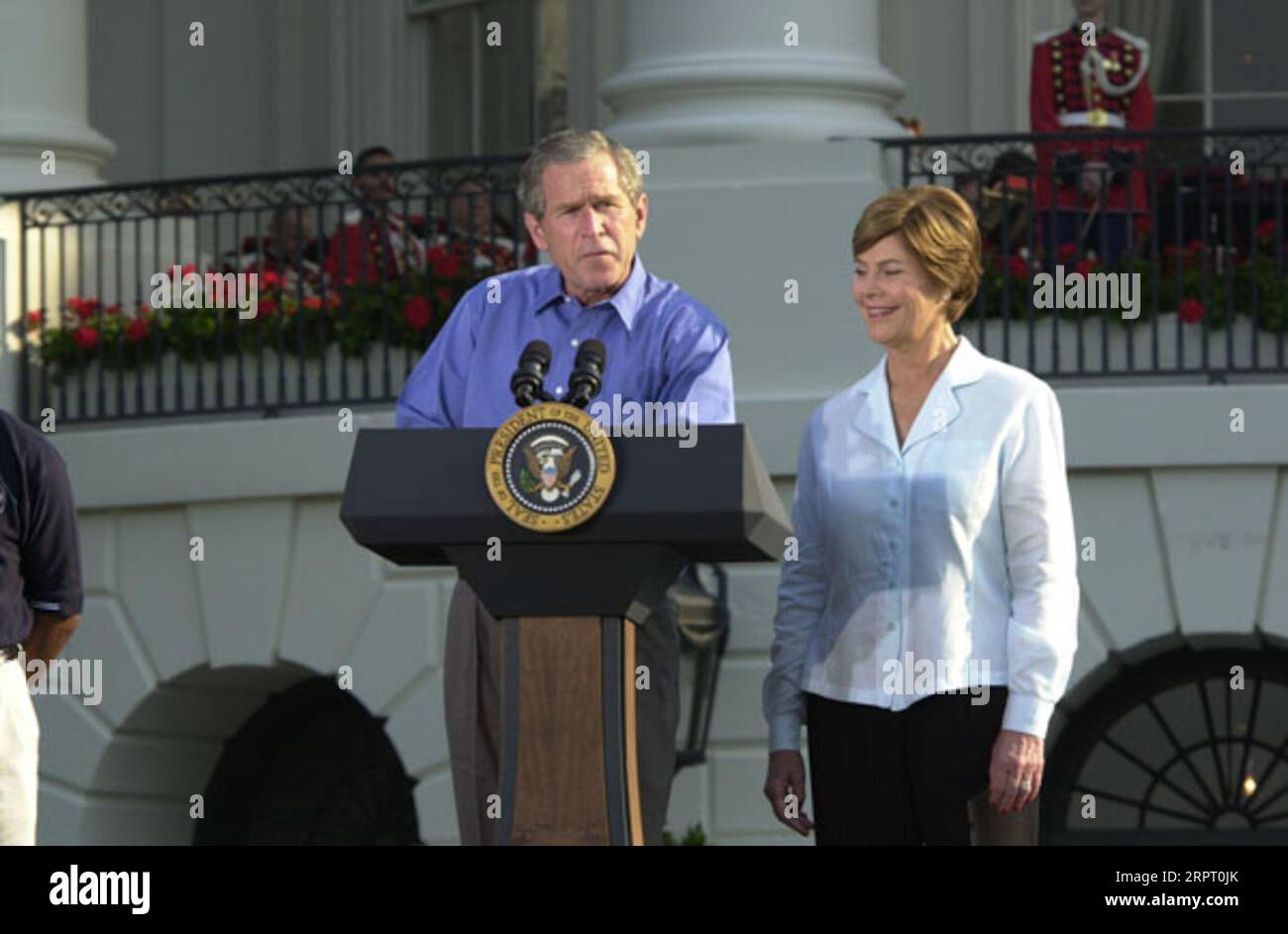 President George Bush, flanked by First Lady Laura Bush, discussing the ...