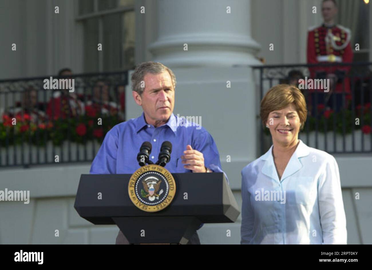 President George Bush, flanked by First Lady Laura Bush, discussing the ...