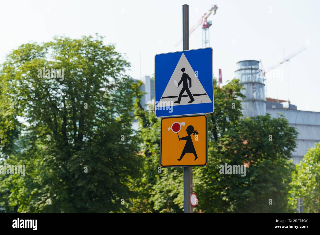 There is a road sign near the road - a pedestrian crossing and the ...