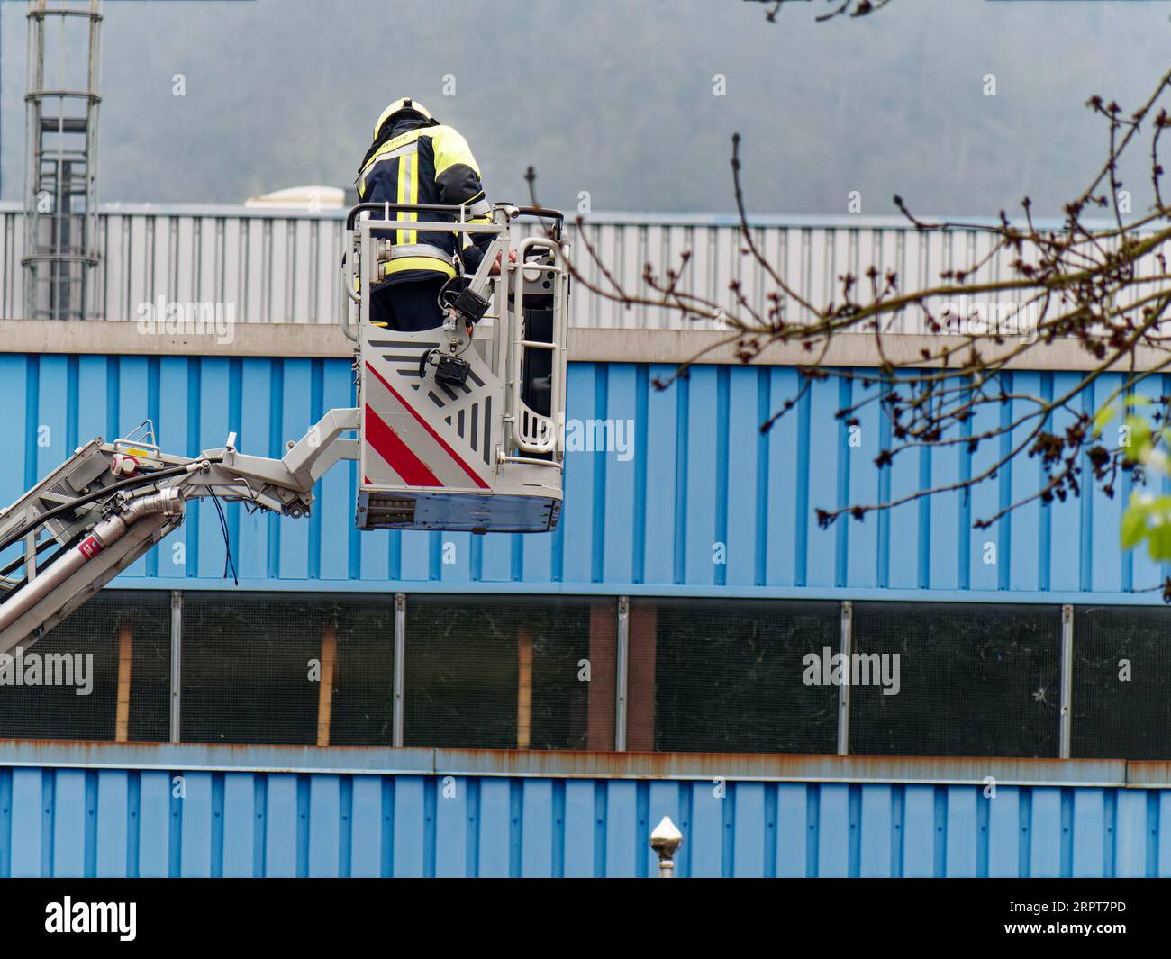 Firefighter tests the turntable ladder to extinguish a possible fire ...