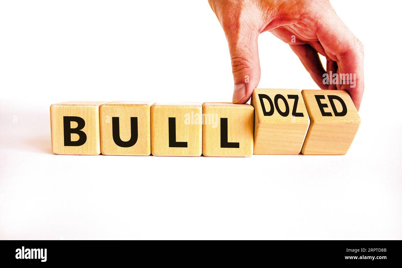 Bull or bulldozed symbol. Businessman turns wooden cubes and changes ...
