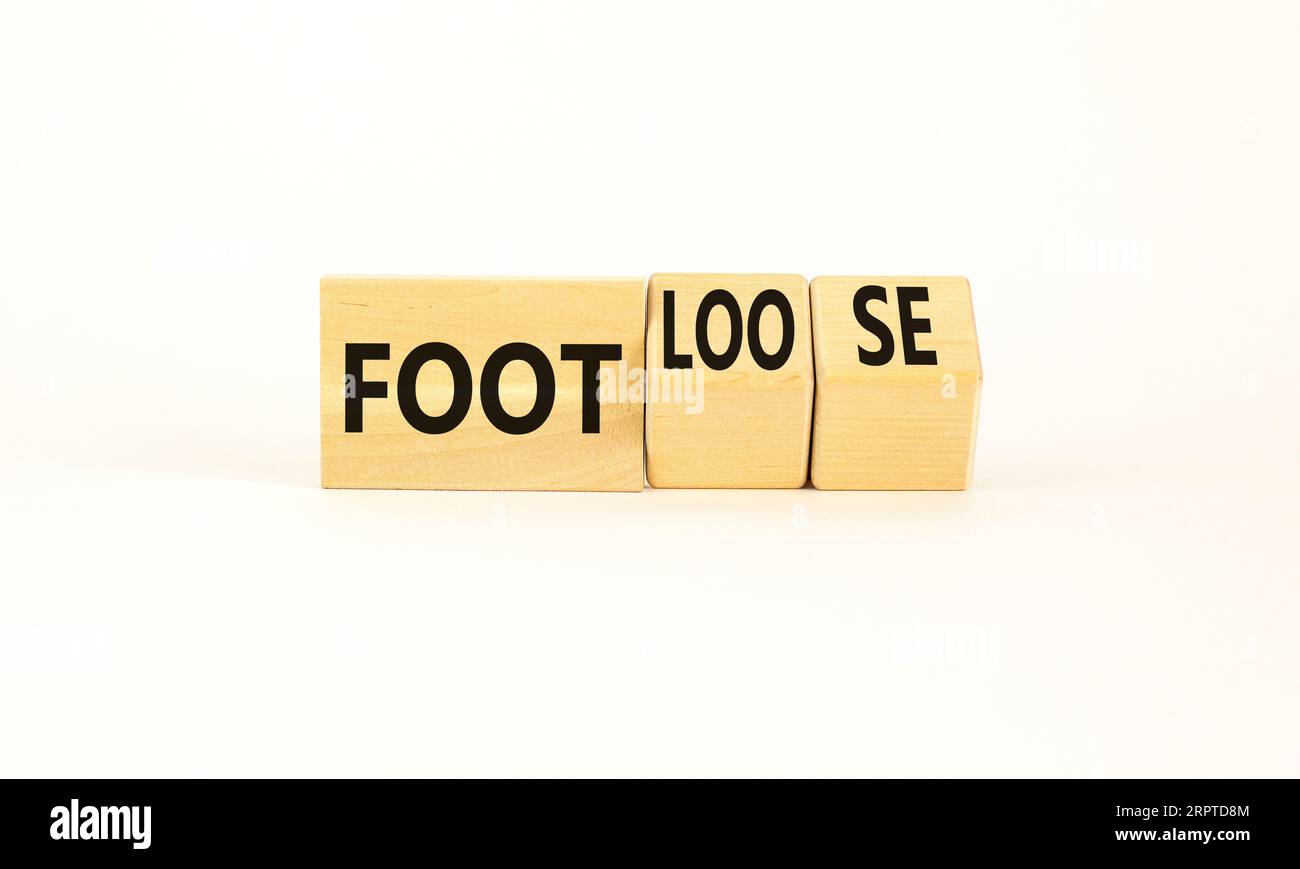 Foot or footloose symbol. Businessman turns wooden cubes and changes ...