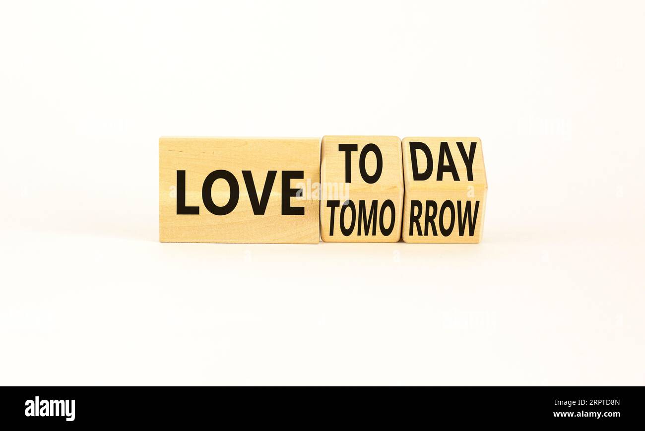 Love today not tomorrow symbol. Businessman turns wooden cubes and ...
