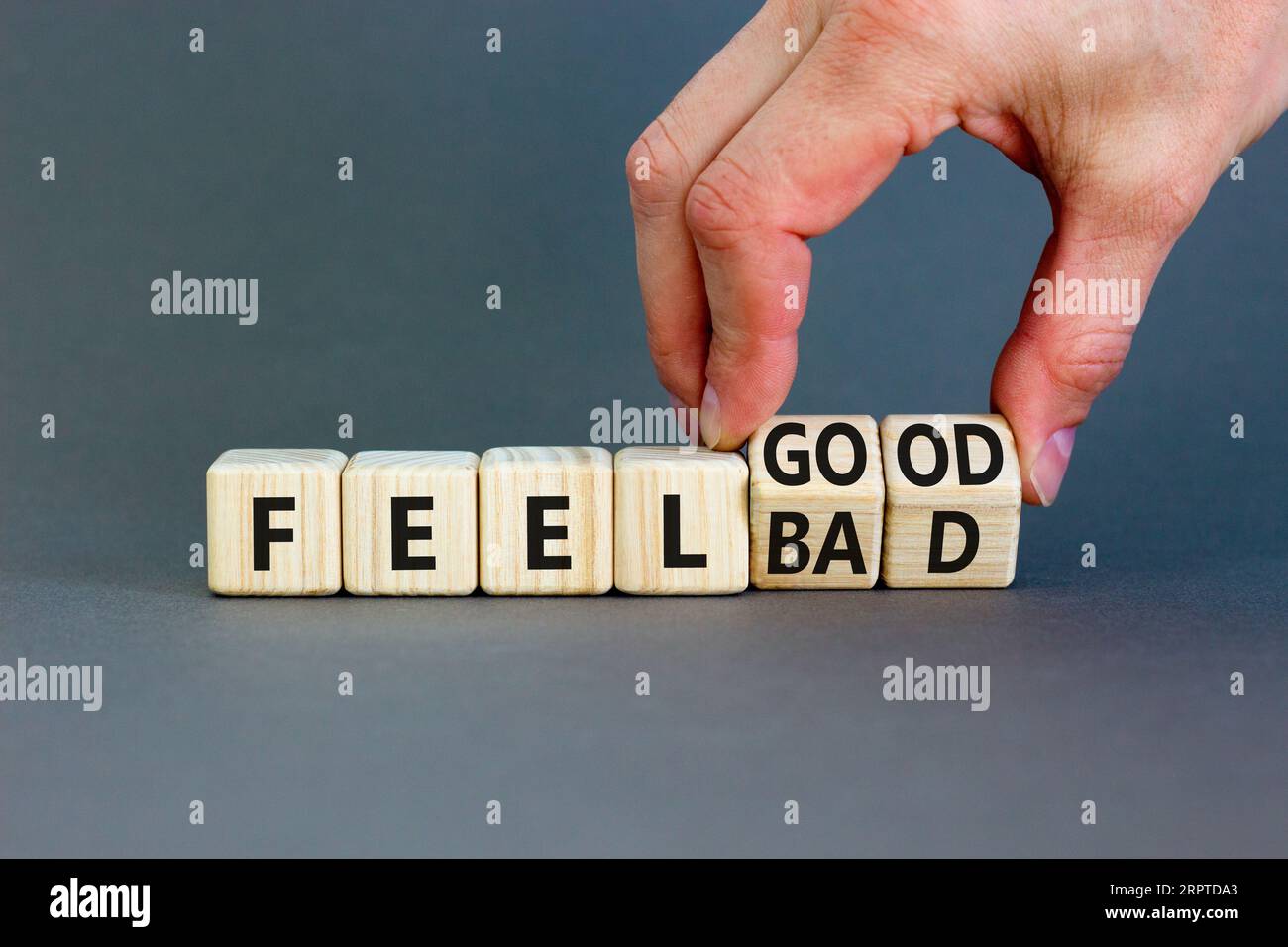 Feel good or bad symbol. Businessman turns wooden cubes and changes word Feel bad to Fell good ...