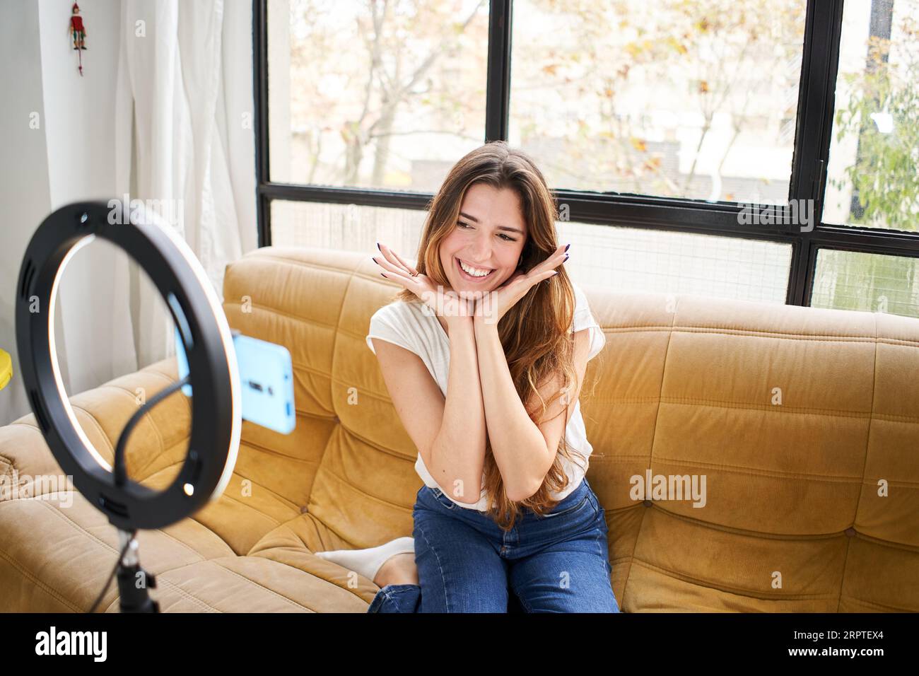 Young beautiful influencer posing smiling for her followers indoors ...