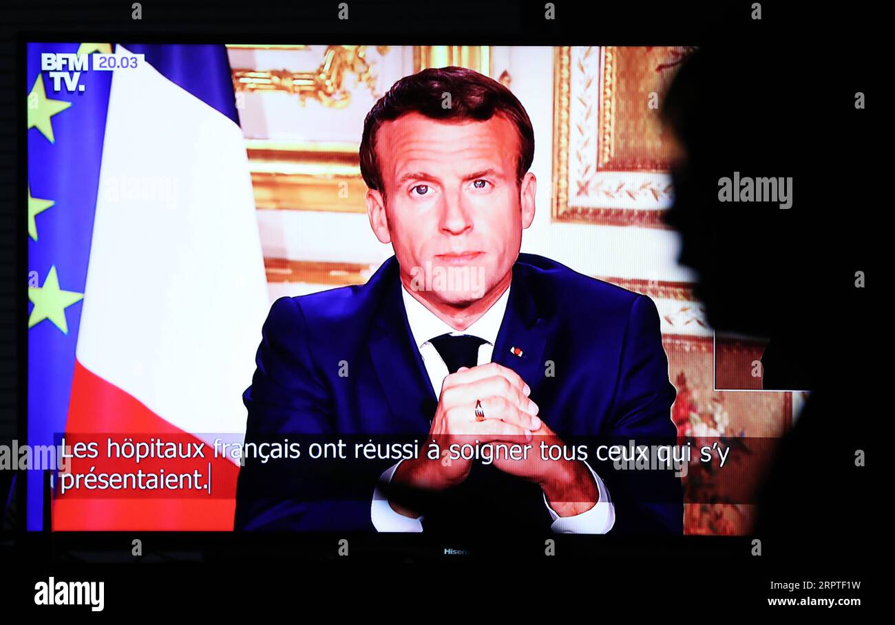 200415 -- BEIJING, April 15, 2020 -- A spectator watches TV as French ...