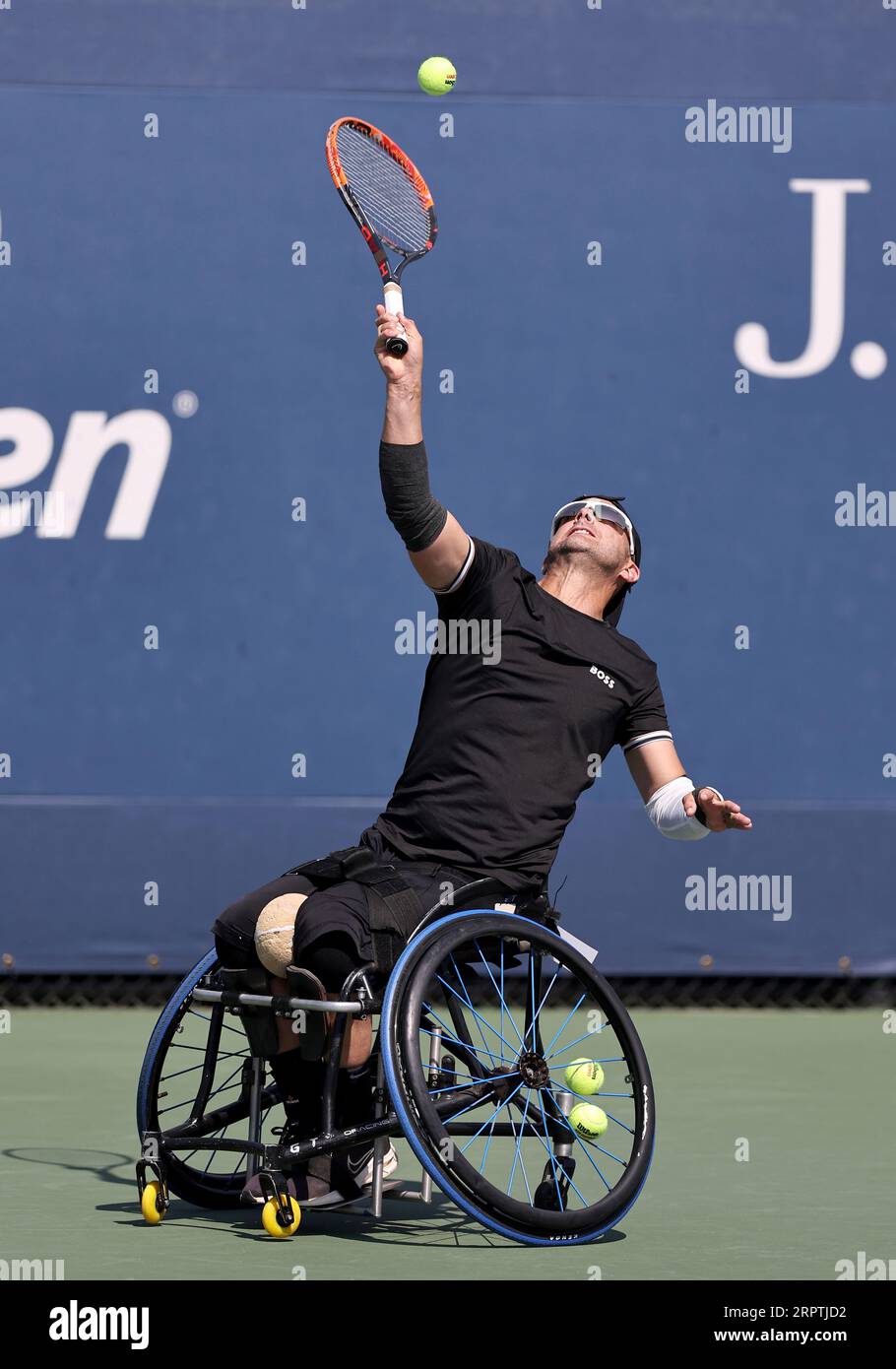 Guy Sasson serves during a wheelchair quad singles match at the 2023 US ...