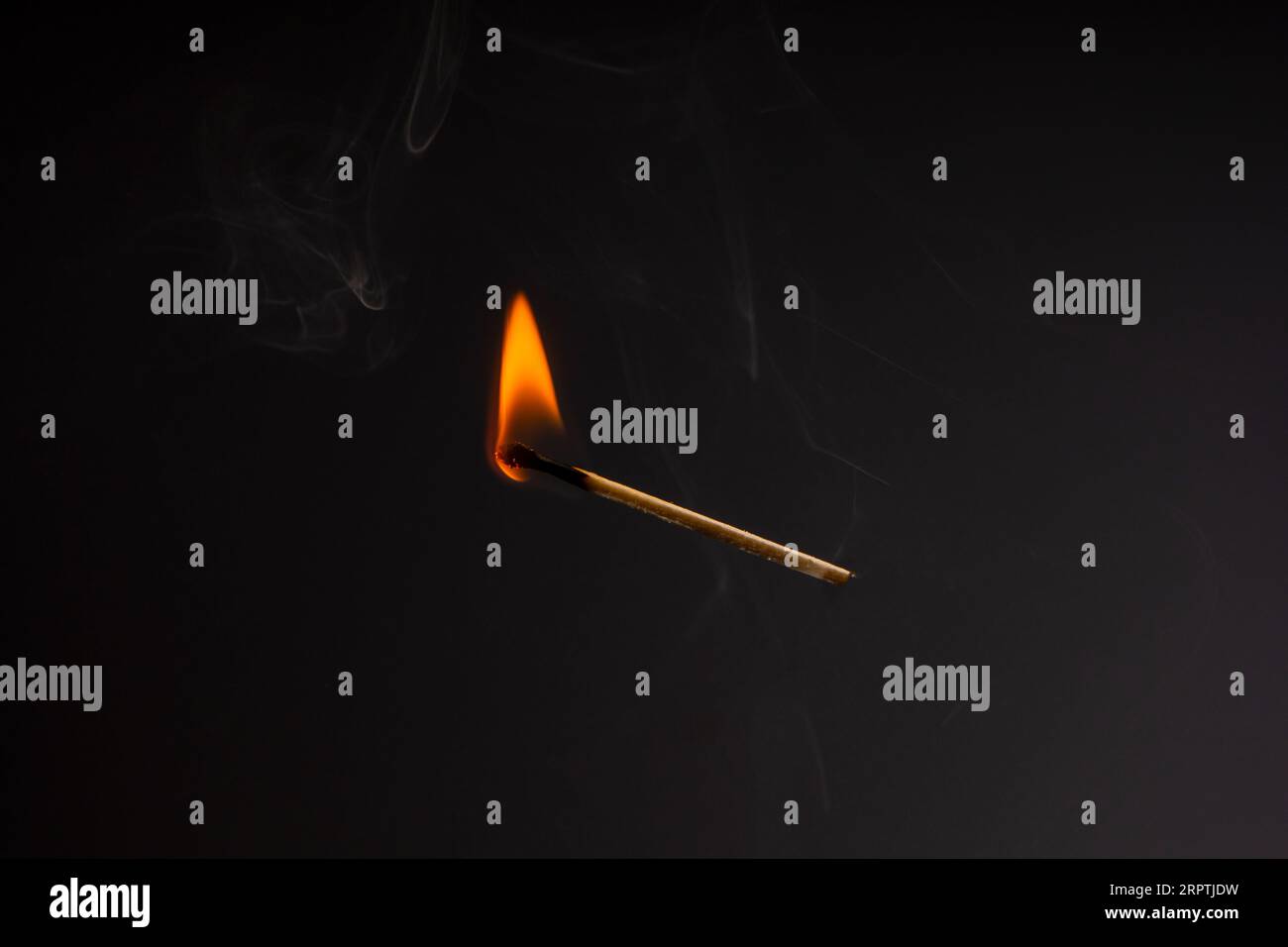 Lit and falling match on a black background Stock Photo - Alamy