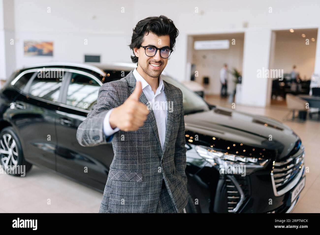 Portrait of successful friendly customer male in business suit showing ...