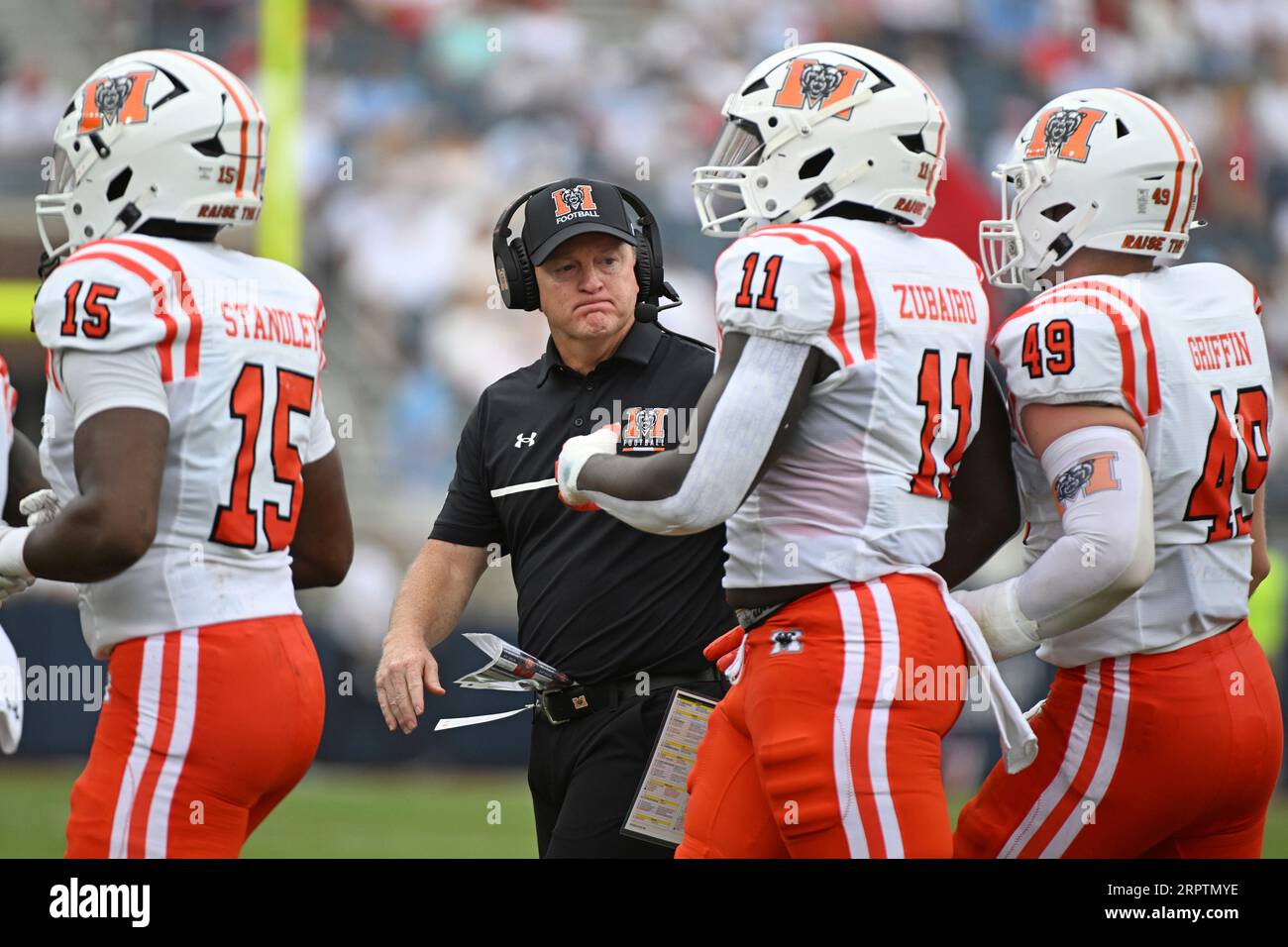 Mercer head coach Drew Cronic talks to players during the first half of an NCAA college football ...