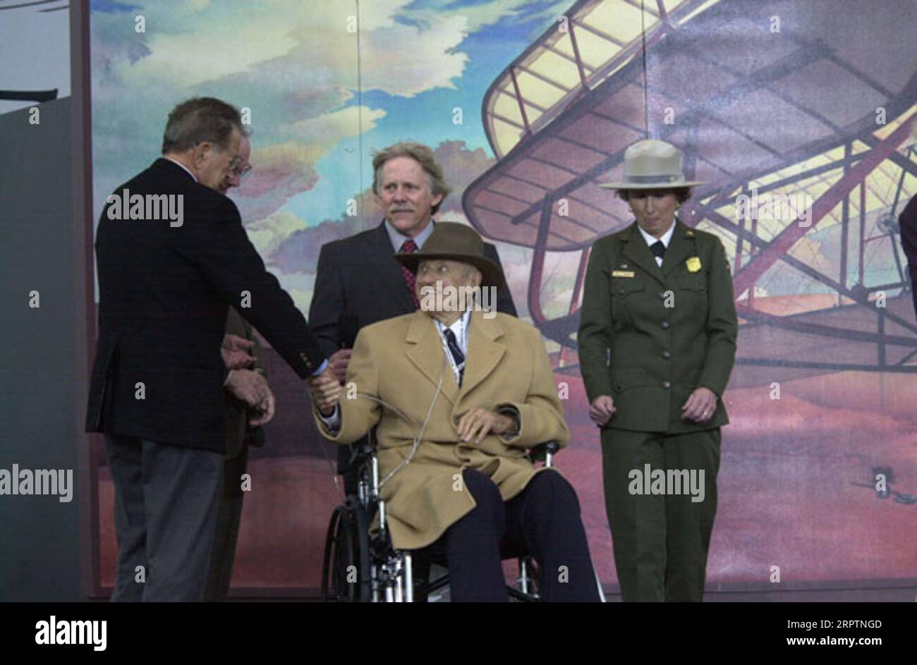 Harry Combs, aviation pioneer, seated in wheelchair, with First Flight ...