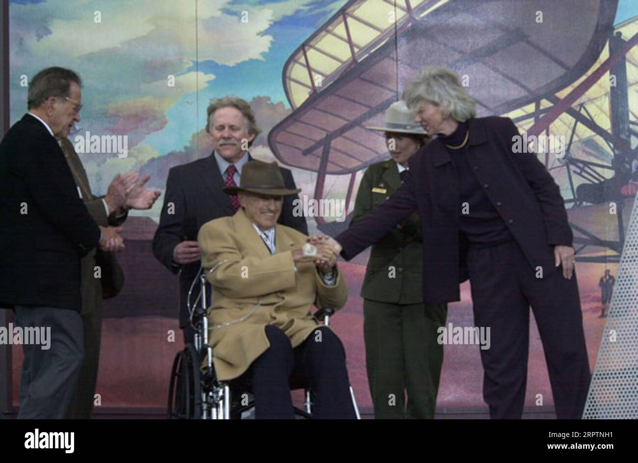 Harry Combs, aviation pioneer, seated in wheelchair, with First Flight ...