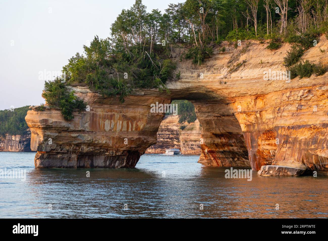Catamaran viewed through a natural arch along Pictured Rocks National ...