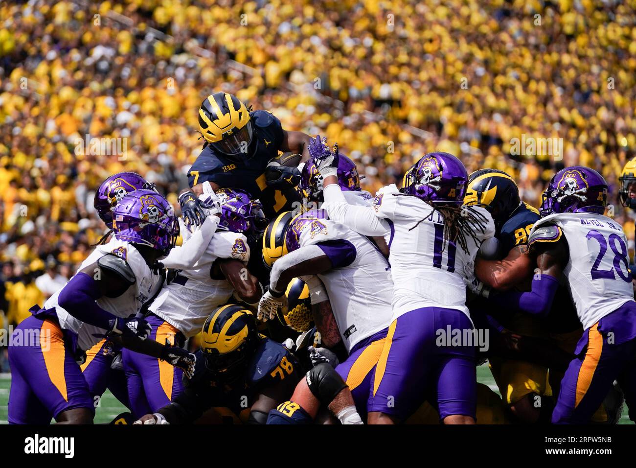 Michigan running back Donovan Edwards (7) is stopped from jumping over ...