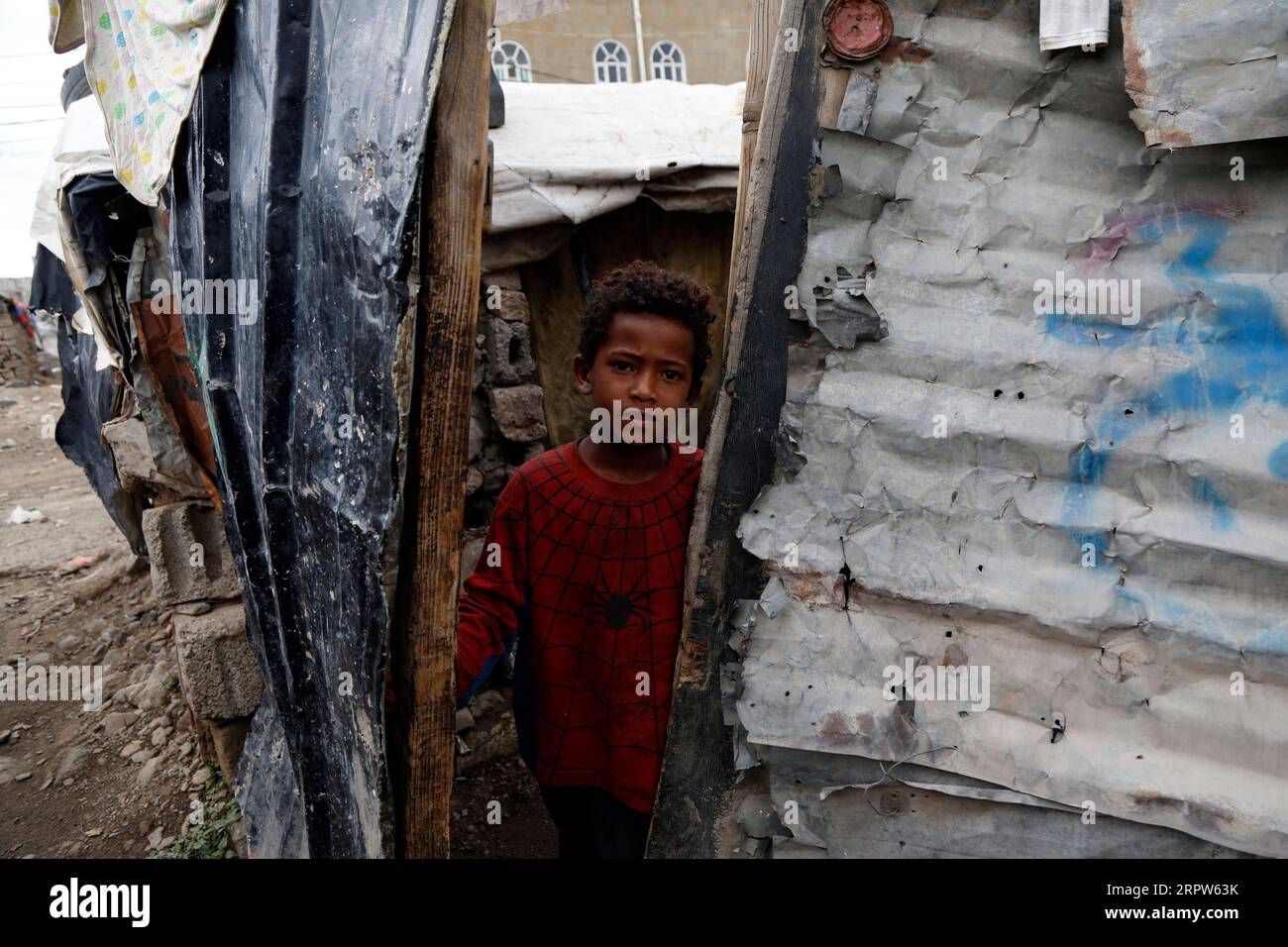 200422 -- SANAA, April 22, 2020 Xinhua -- A child looks out through his ...