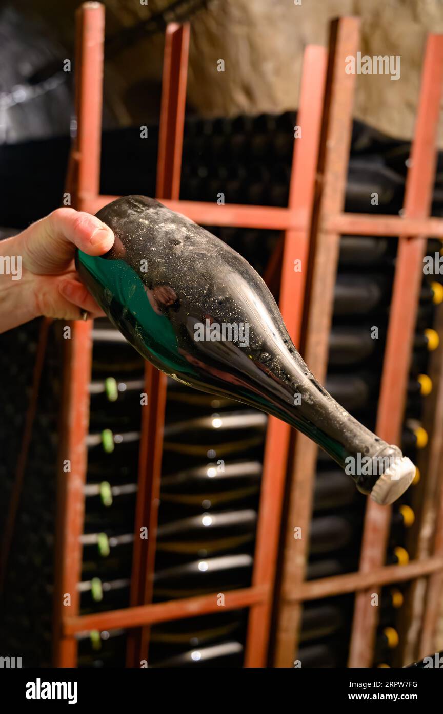 Checking of sediment in undergrounds caves with bottles on wooden racks ...