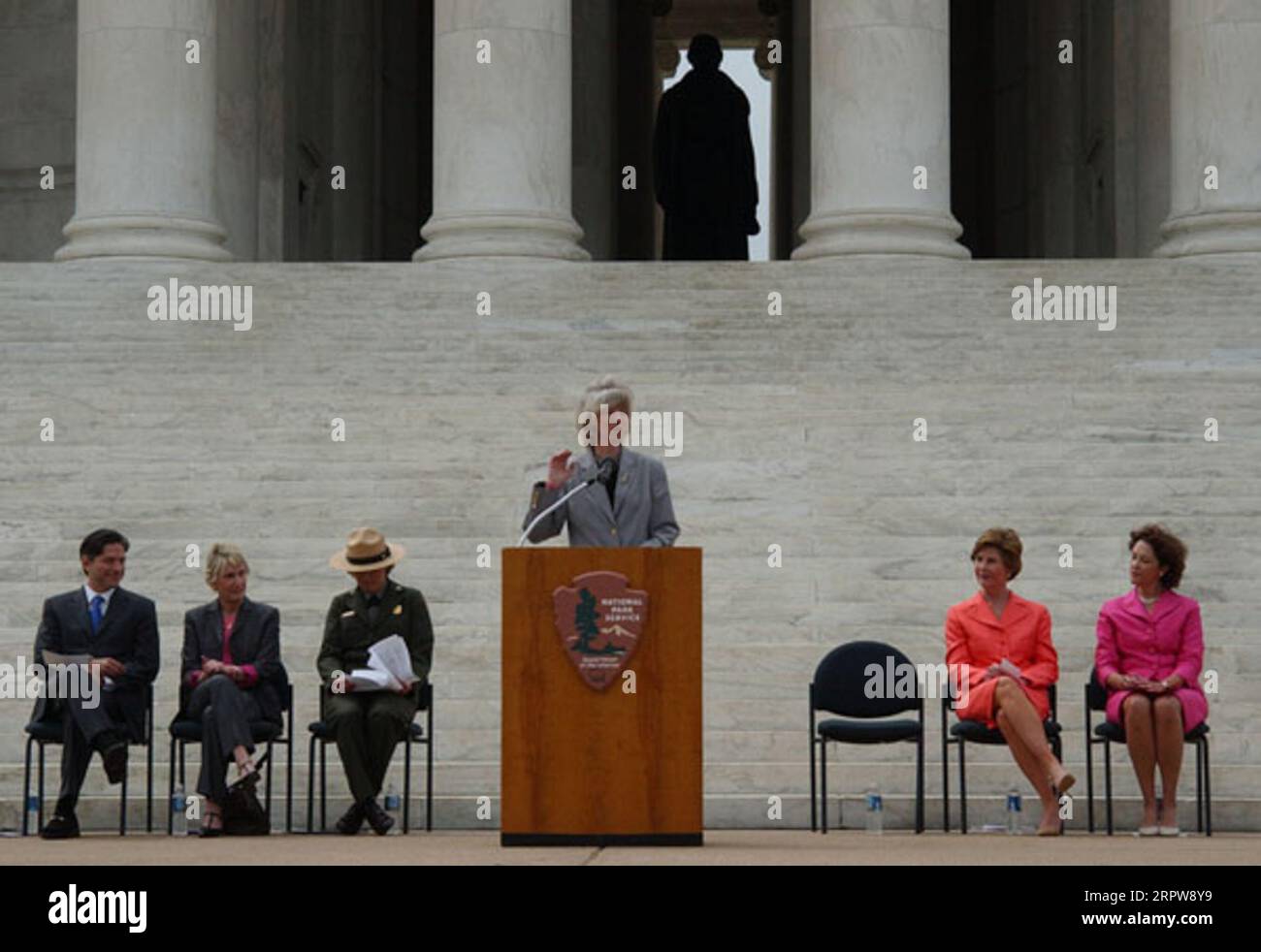 Secretary Gale Norton speaking, with First Lady Laura Bush seated to ...