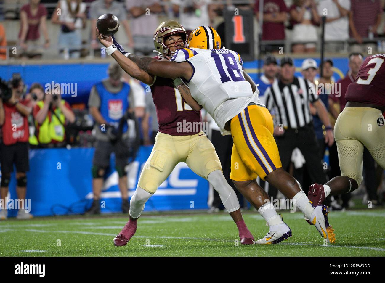 Florida State quarterback Jordan Travis (13) is hit by LSU defensive ...