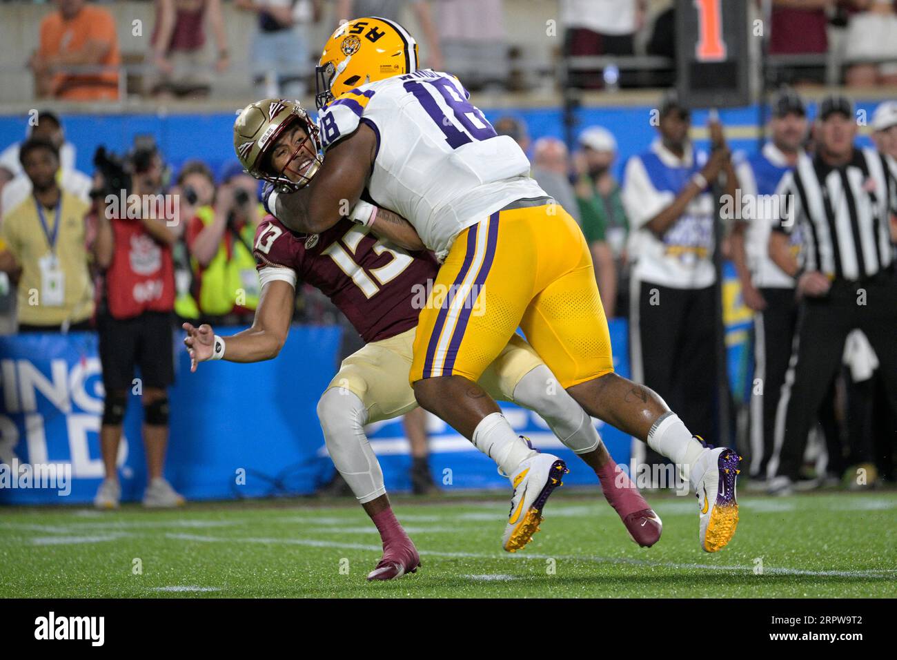 Florida State quarterback Jordan Travis (13) is hit by LSU defensive ...