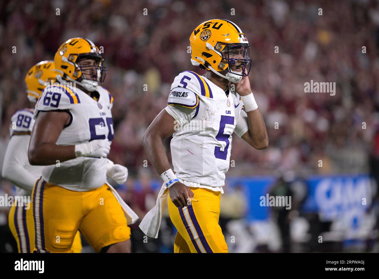 LSU quarterback Jayden Daniels (5) jogs off of the field after a series ...