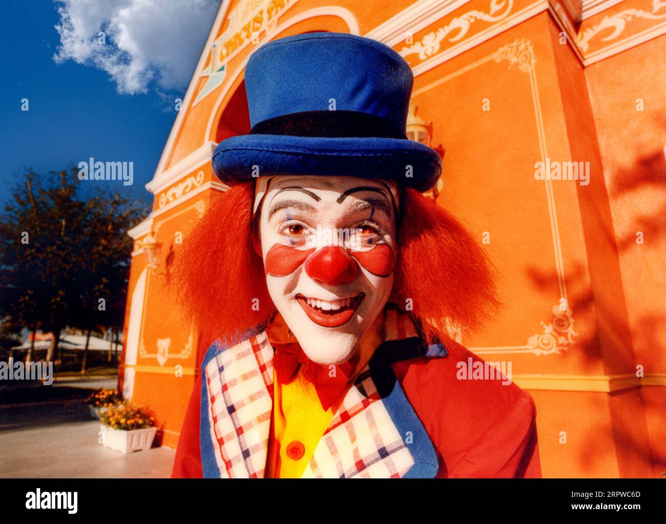 Retro Clown surreal with traditional red nose posing outdoors in sunny ...