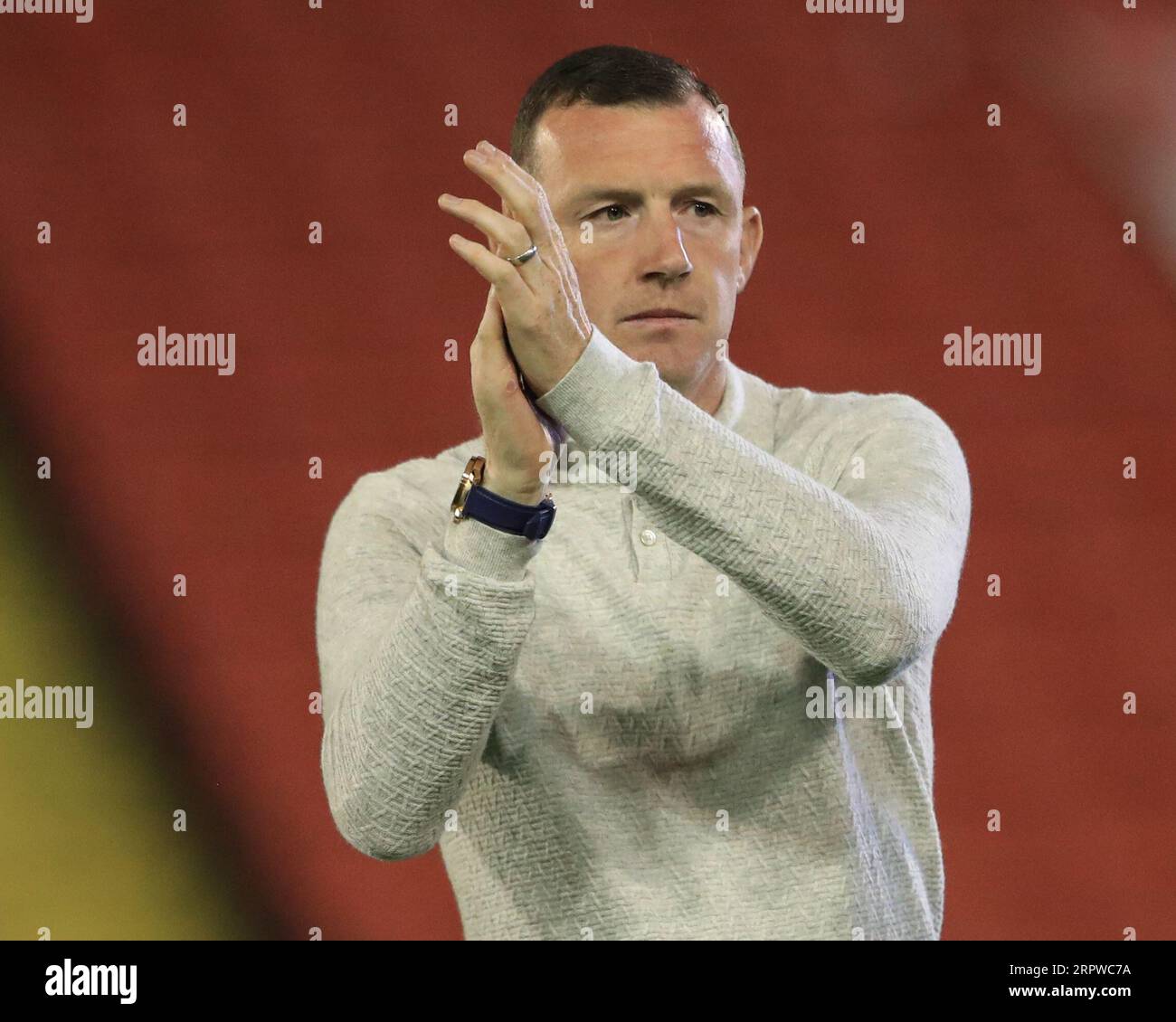 Neill Collins Head coach of Barnsley applauds the home fans after his ...