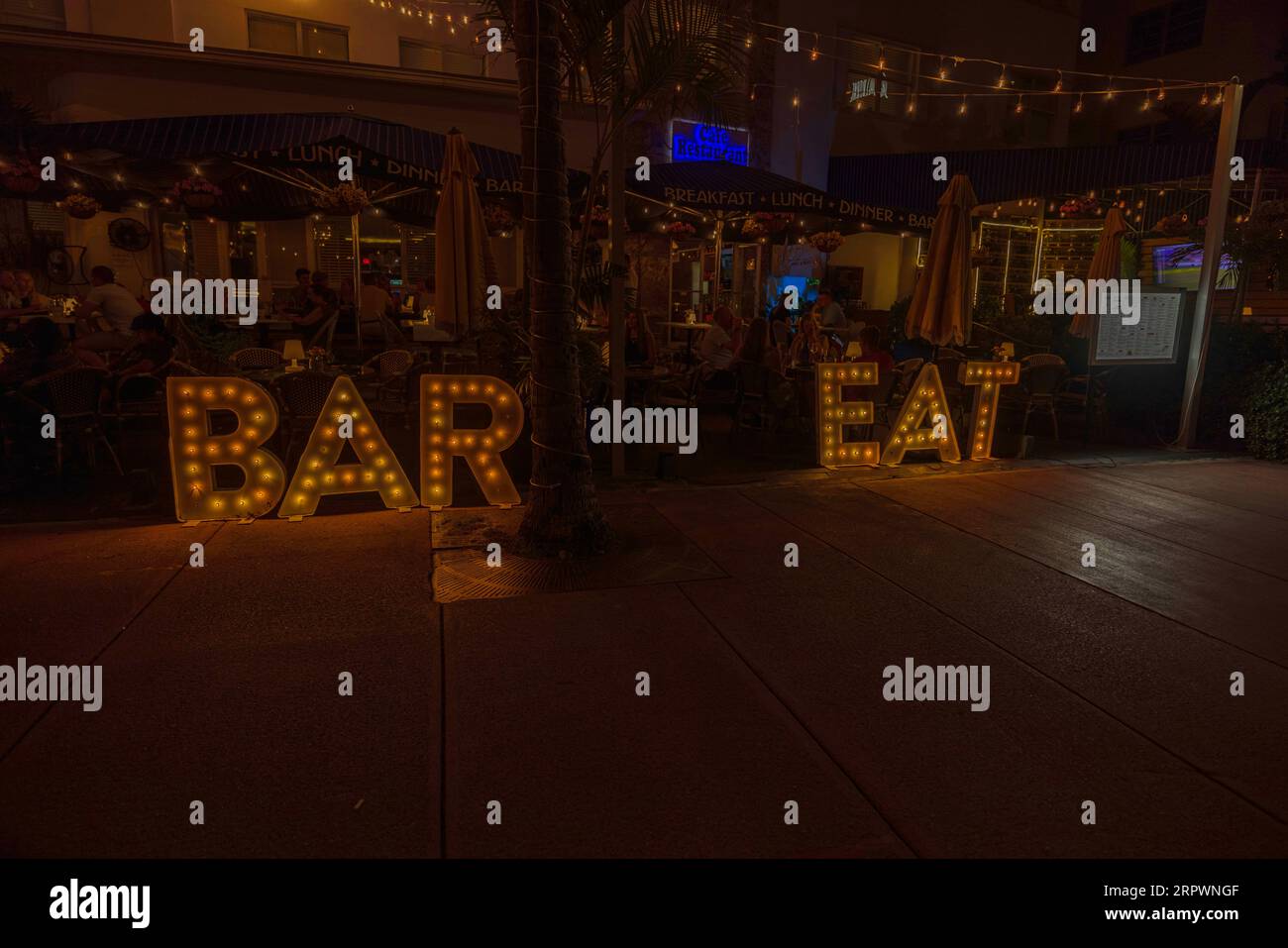 Cityscape view with led lights banner welcoming people to eat. Miami ...