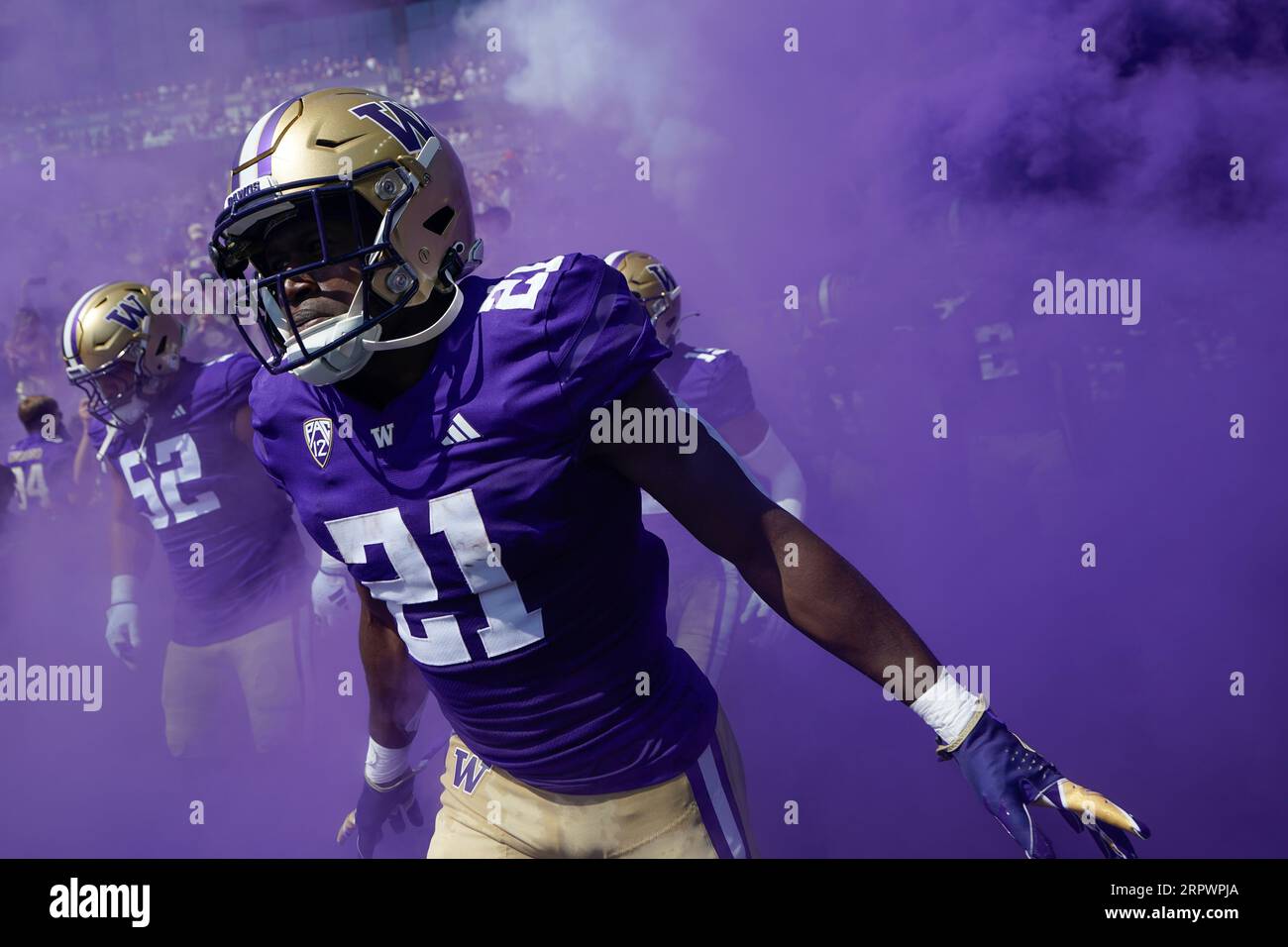 Washington players, including running back Daniyel Ngata, run out to ...