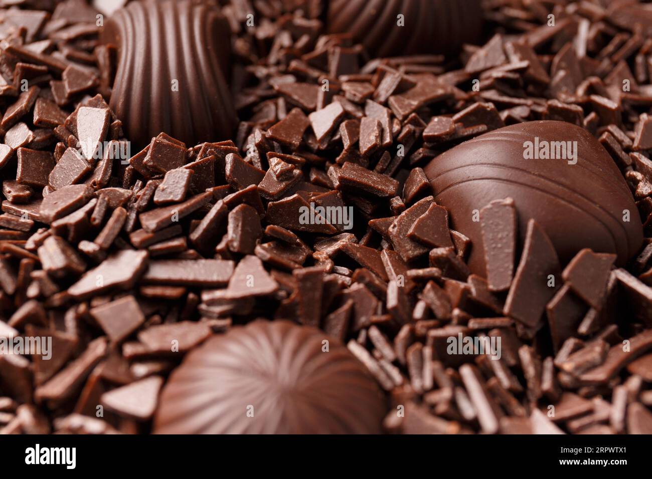 Beautifully shaped dark chocolate sweets dipped in chocolate chips ...