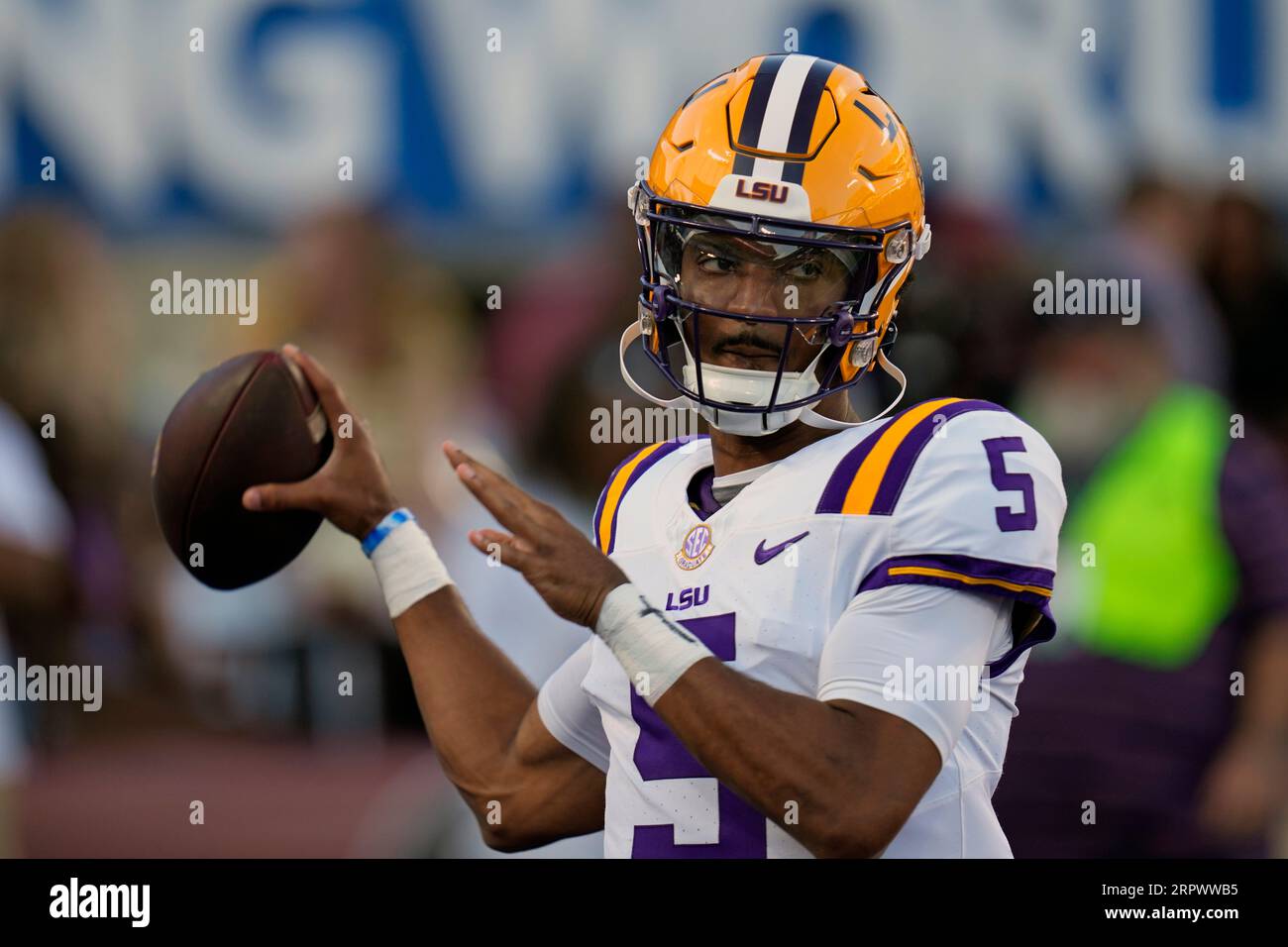 LSU quarterback Jayden Daniels (5) warms up before an NCAA college ...